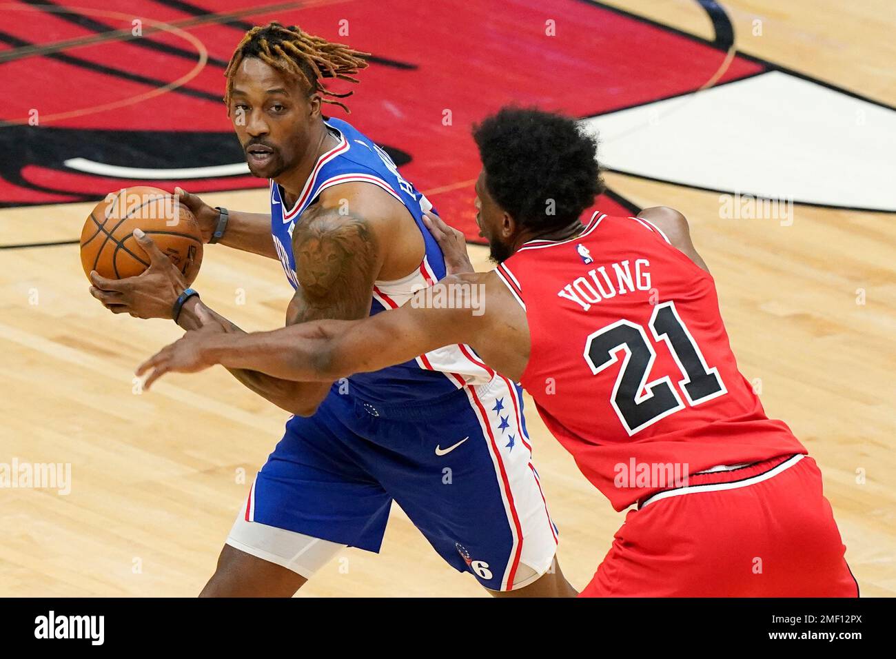 Philadelphia 76ers center Dwight Howard, left, looks to pass the ball ...