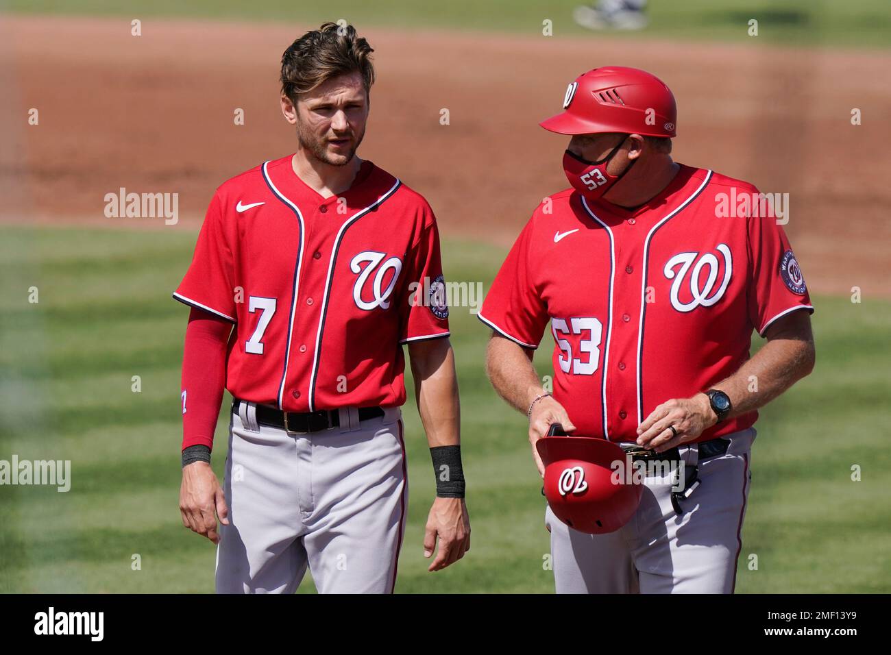 Washington Nationals' Trea Turner (7) walks with first base coach Randy ...