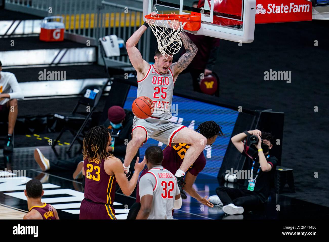 Ohio State forward Kyle Young (25) gets a dunk over Minnesota center ...