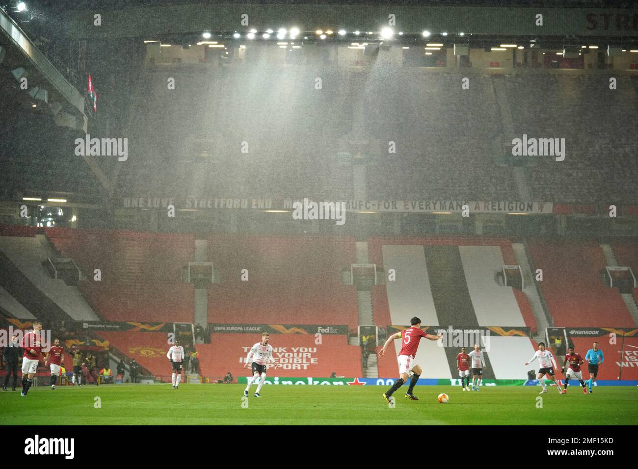 Players in action under heavy rain during the Europa League round of 16 ...