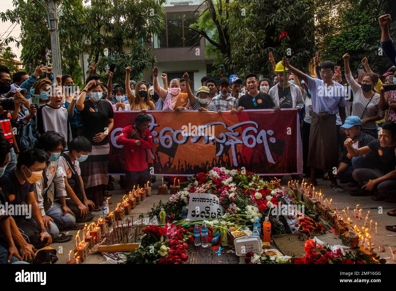 People shout slogans and light candles to honor Chit Min Thu, where he ...