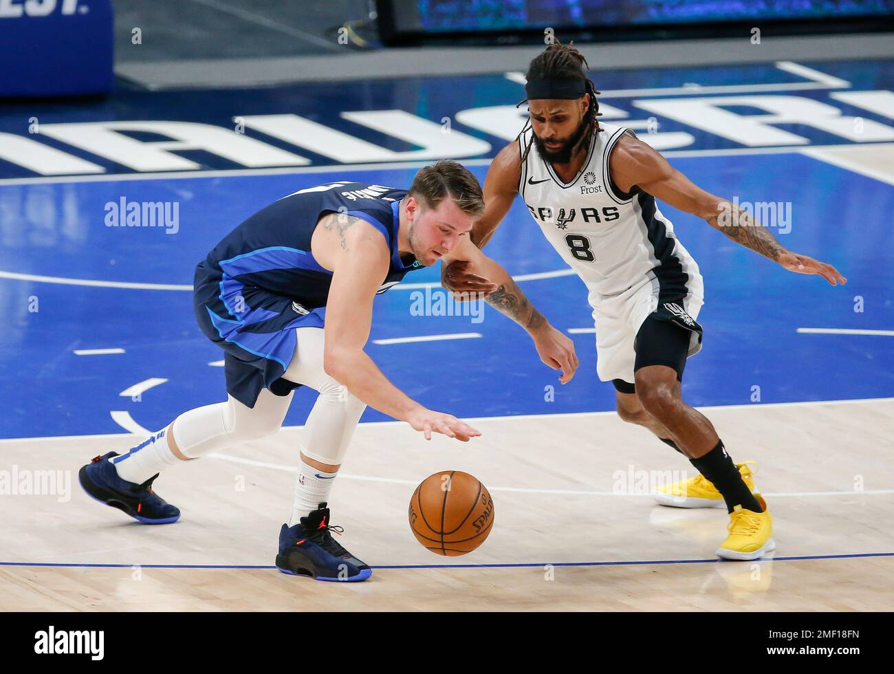 Dallas Mavericks guard Luka Doncic (77) battles San Antonio Spurs guard ...