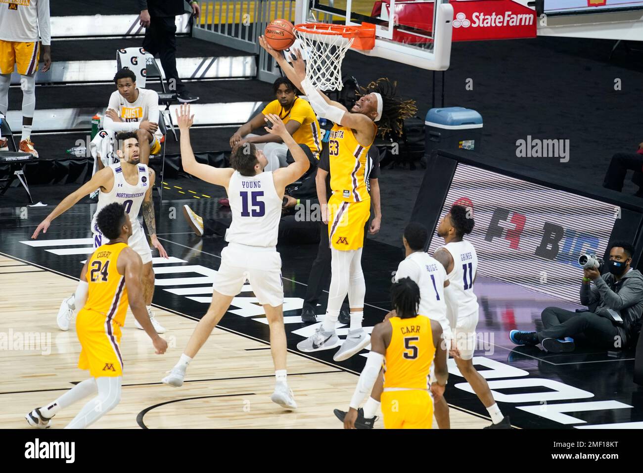 Minnesota's Brandon Johnson (23) puts up a shot against Northwestern's ...