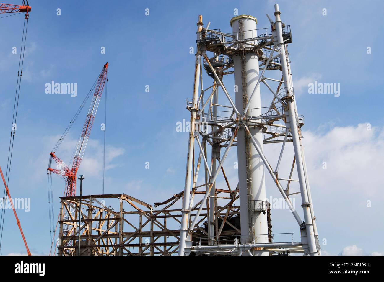 This photo shows the damaged Unit 1 reactor, back, and part of the ...
