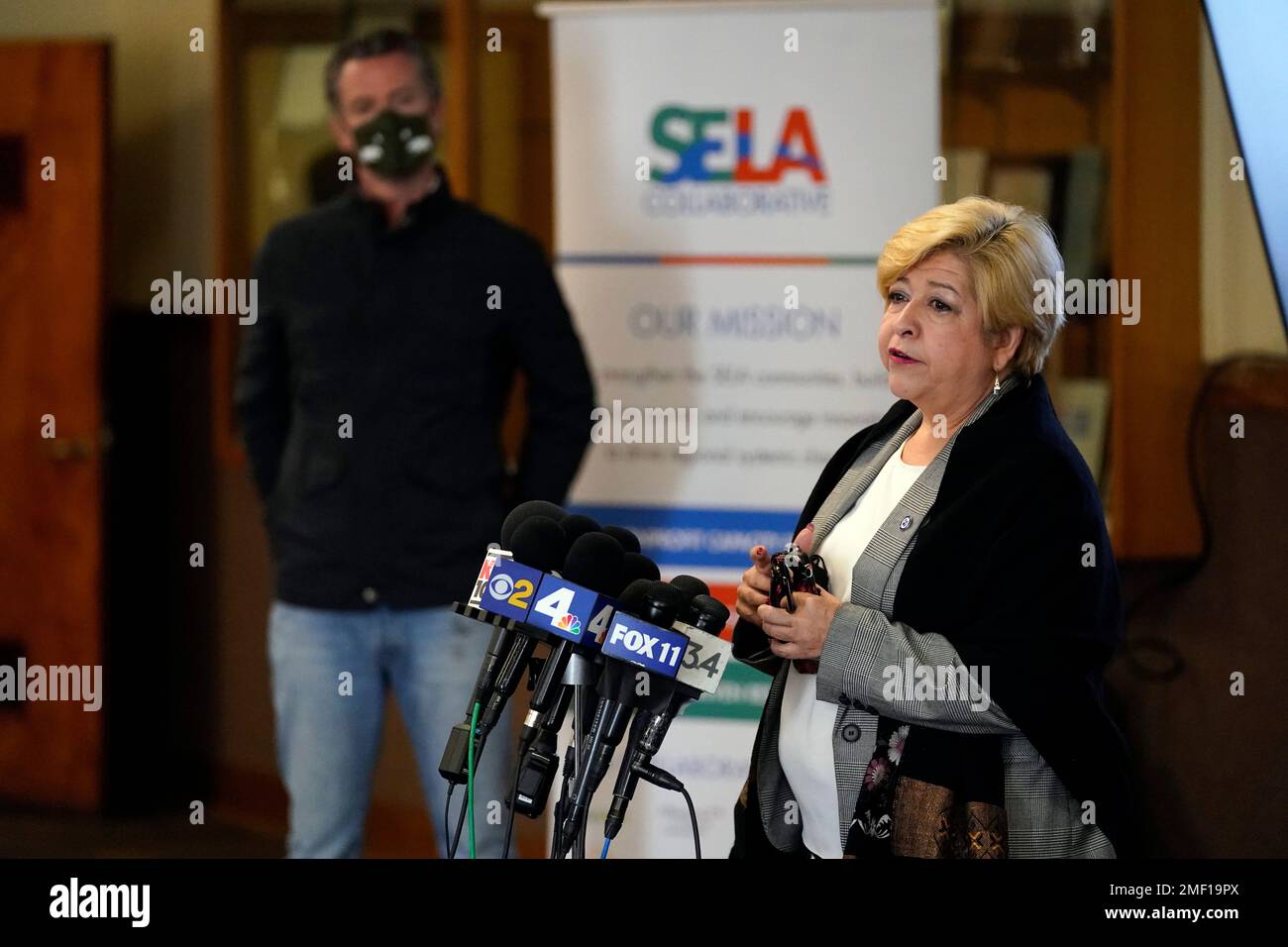 South Gate Mayor Maria Davila, right, speaks as California Gov. Gavin ...