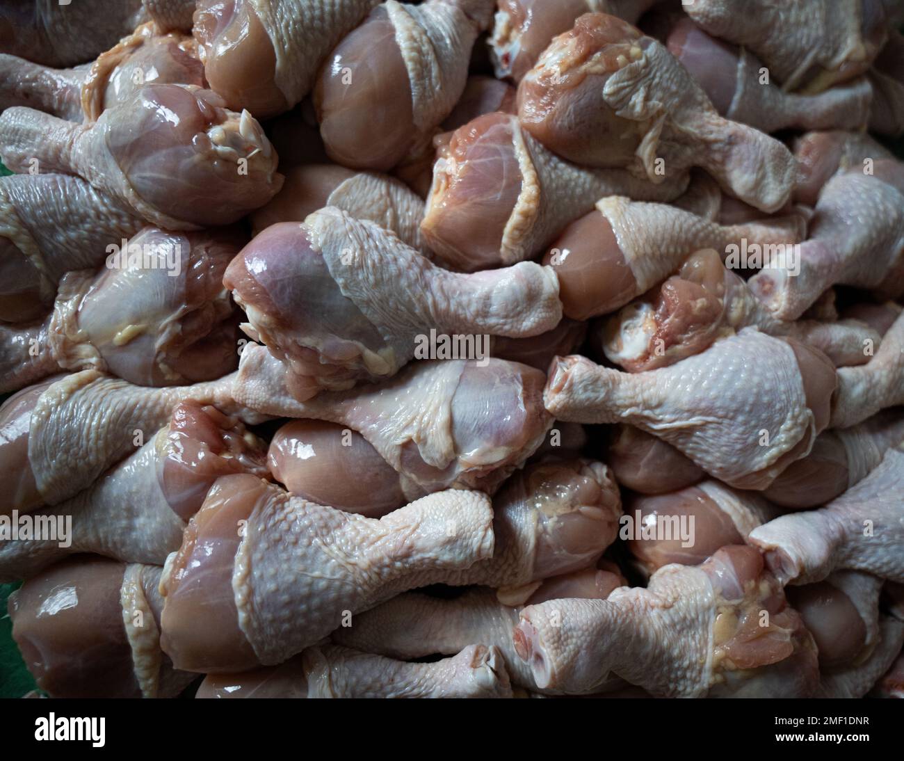 Raw chicken legs big heap on the table background Stock Photo - Alamy