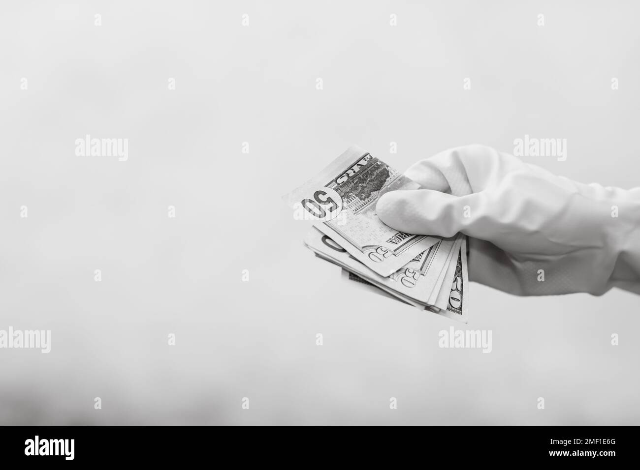 Hand with gloves receiving, giving or holding USD EURO banknote. World ...