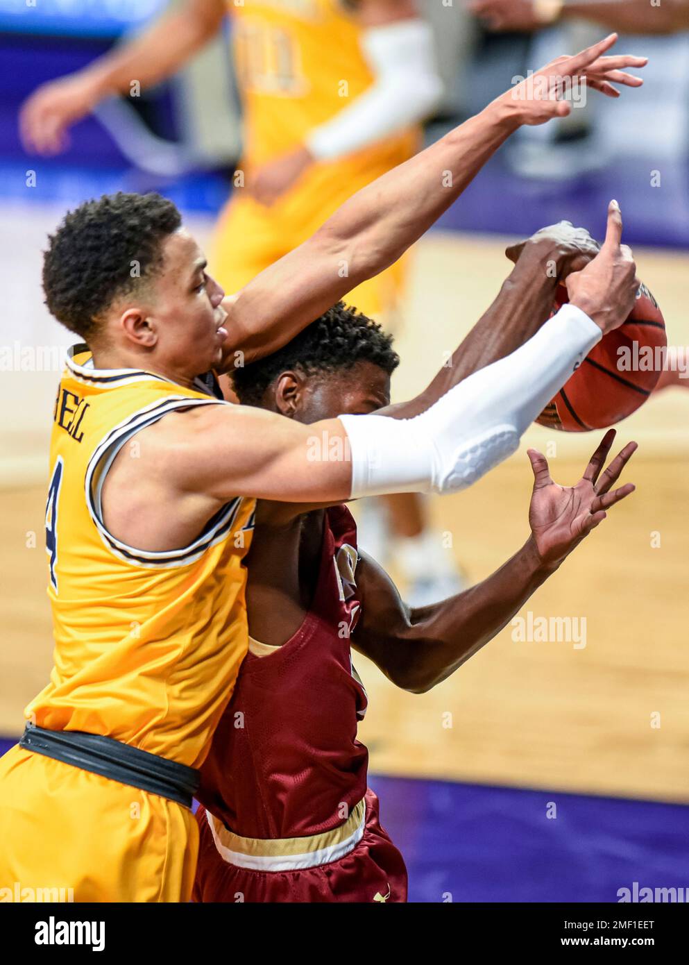 Elon guard Darius Burford (12) is fouled by Drexel guard Xavier Bell (4 ...