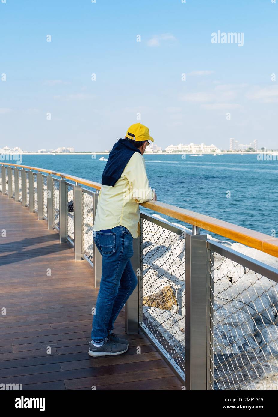 Middle aged man walking at seaside walkway Stock Photo - Alamy