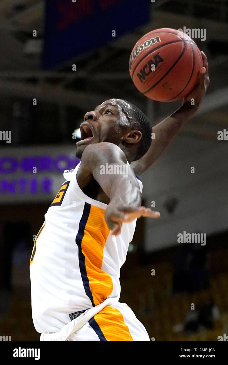 UNC-Greensboro guard Isaiah Miller drives to the basket against Mercer ...