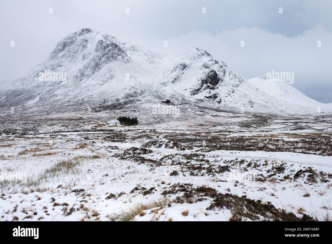 Winter wonderland view of Lagangarbh Cottage and snow covered mountains ...