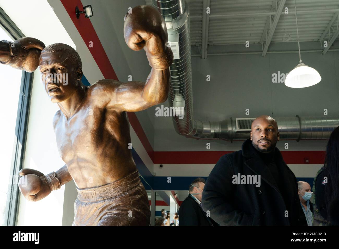 Joe Frazier Jr., looks at a statue of his father Joe Frazier, left ...