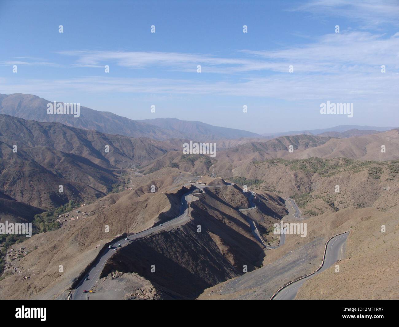 A beautiful view of roads with cars on a hill under the blue sky during ...