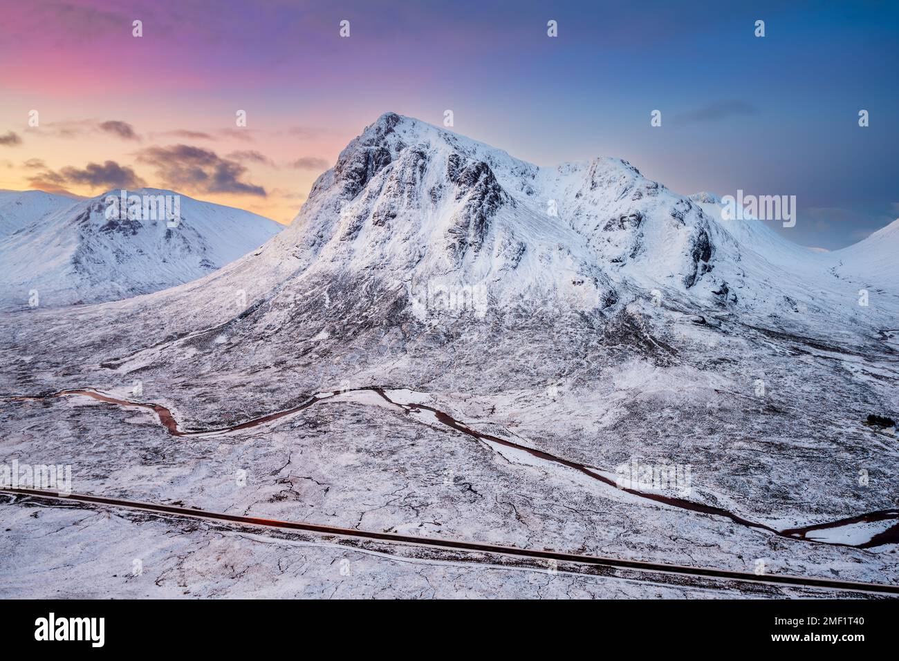 Famous Scottish mountains covered in snow at sunrise. Glencoe, Scotland ...