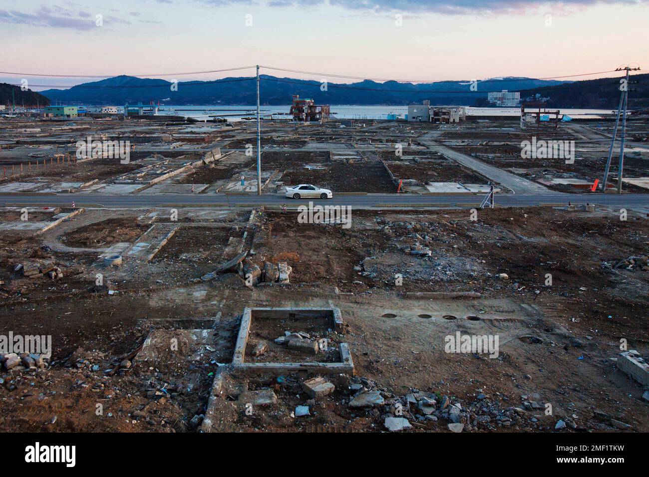In this Feb. 23, 2012, file photo, a car passes through the leveled ...