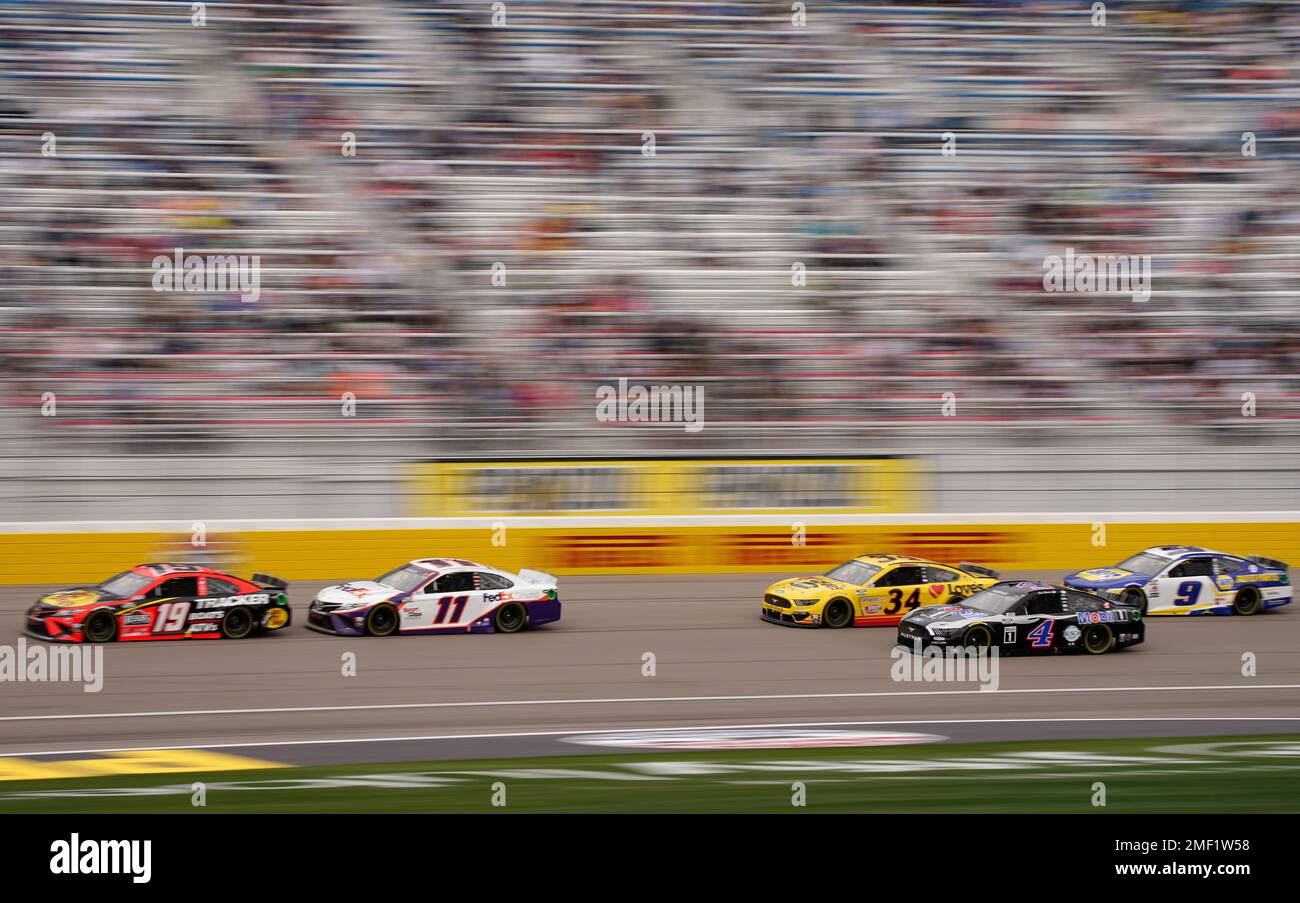 Cars drive around the track during a NASCAR Cup Series auto race Sunday ...