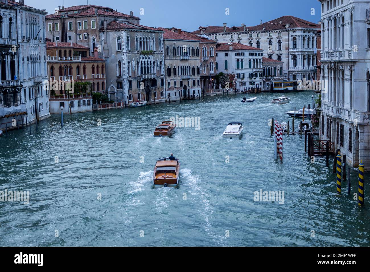 Moving the famous gondolas through the canals of Venice Stock Photo - Alamy