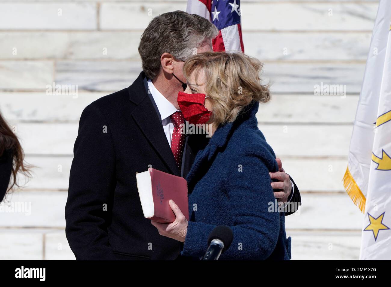 Rhode Island Democratic Gov. Dan McKee, behind, embraces his wife Susan ...
