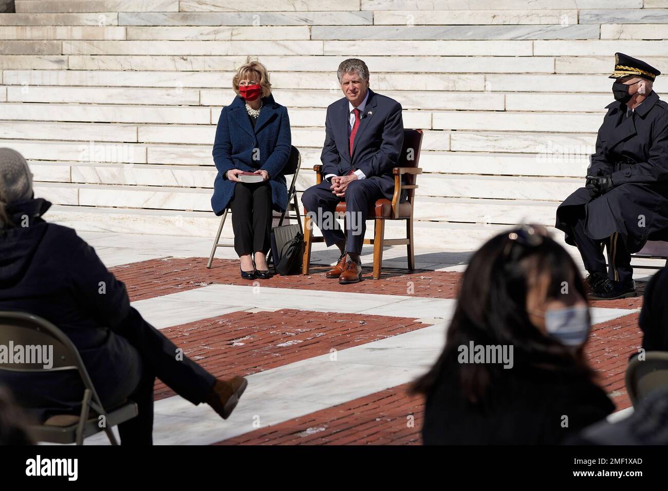 Rhode Island Democratic Gov. Dan McKee, center right, is seated with ...