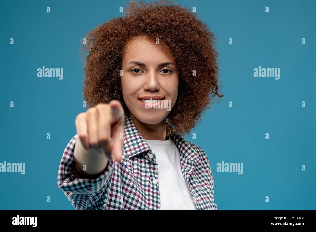 Smiling woman pointing to someone with her finger Stock Photo - Alamy