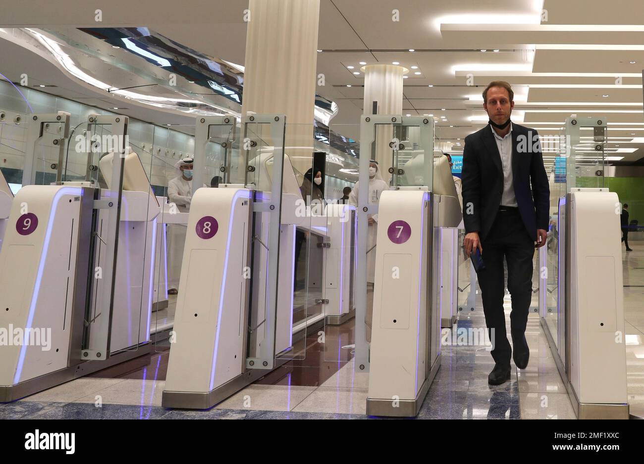 A man goes through an automated gate after he passed through the face ...