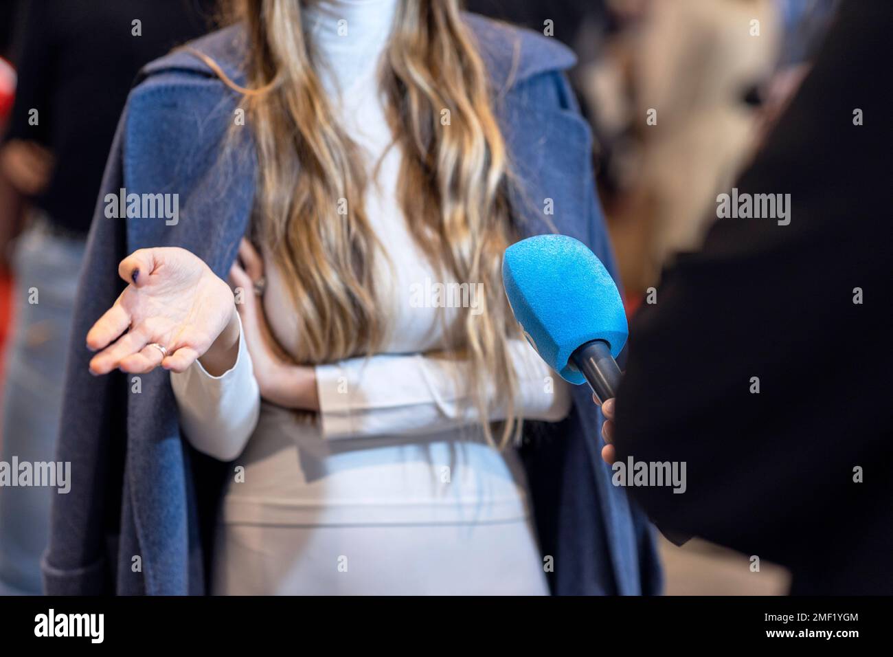 TV journalist making media or vox pop interview with unrecognizable ...