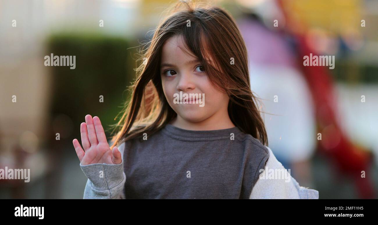 Little girl raising arms saying stop with hand gesture Stock Photo - Alamy