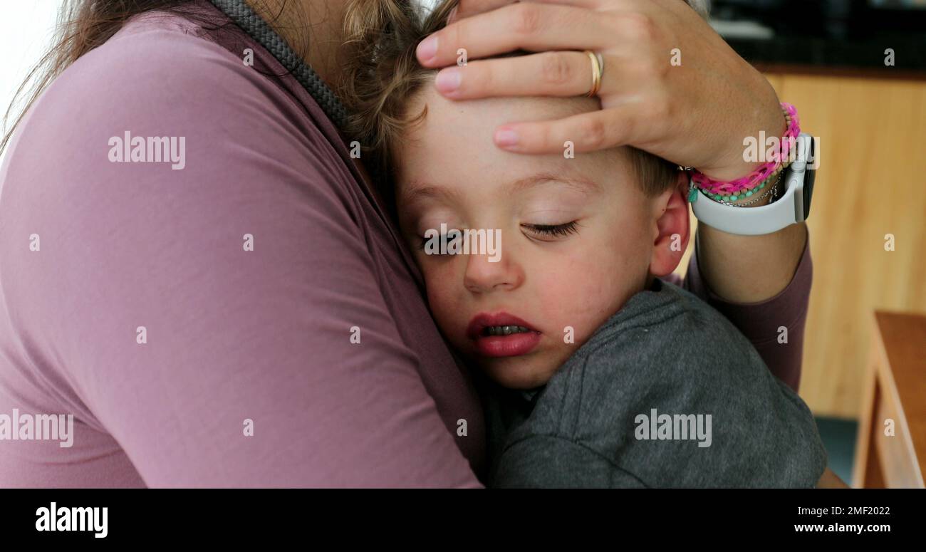 Mother caressing child hair mom cuddling toddler Stock Photo - Alamy