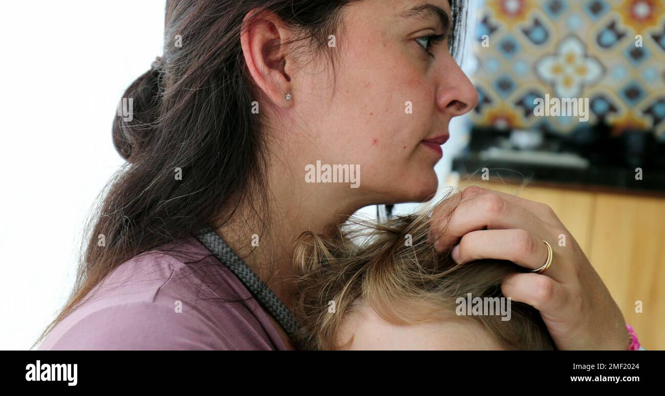 Mother caressing child hair mom cuddling toddler Stock Photo - Alamy