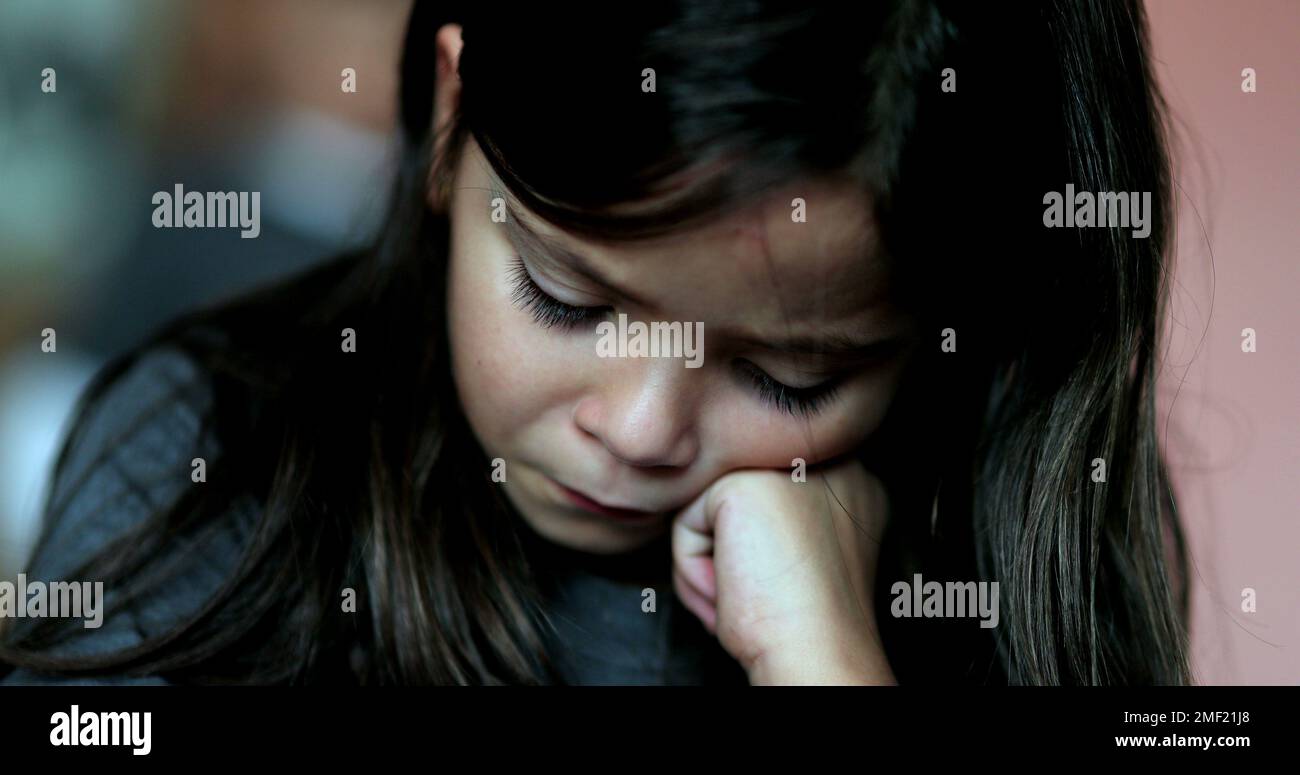 Sad child little girl with depressed emotion Stock Photo - Alamy