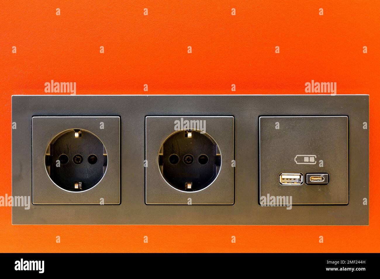 A modern black 220V, USB and USB C socket block is built into the ...