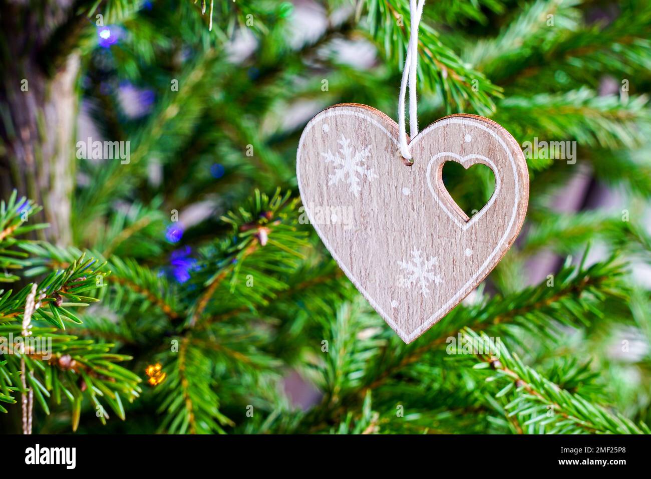 A miniature wooden heart with a small heart-shaped cutout and a ...
