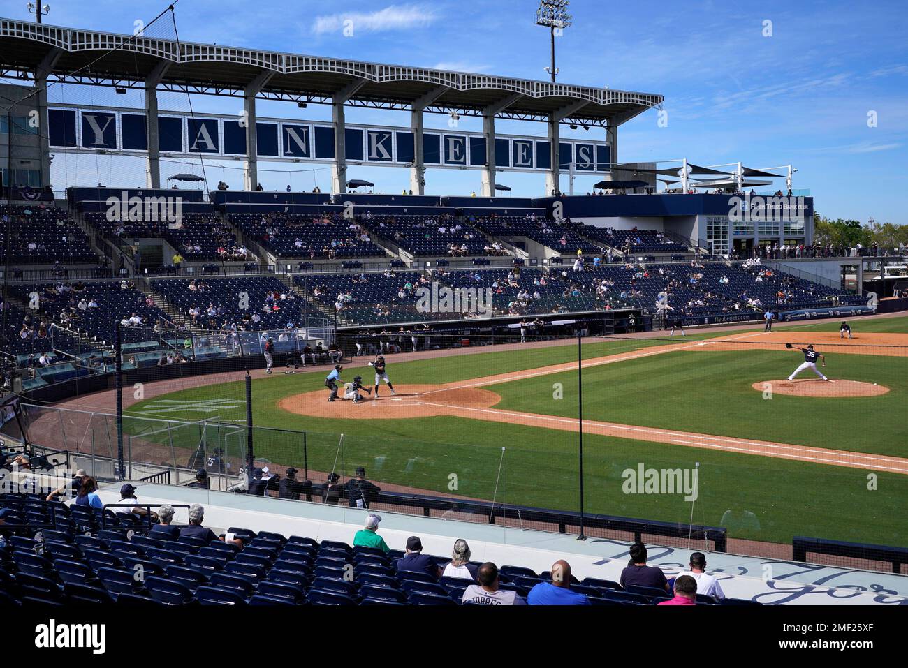 Socially distanced fans watch a spring training exhibition baseball ...