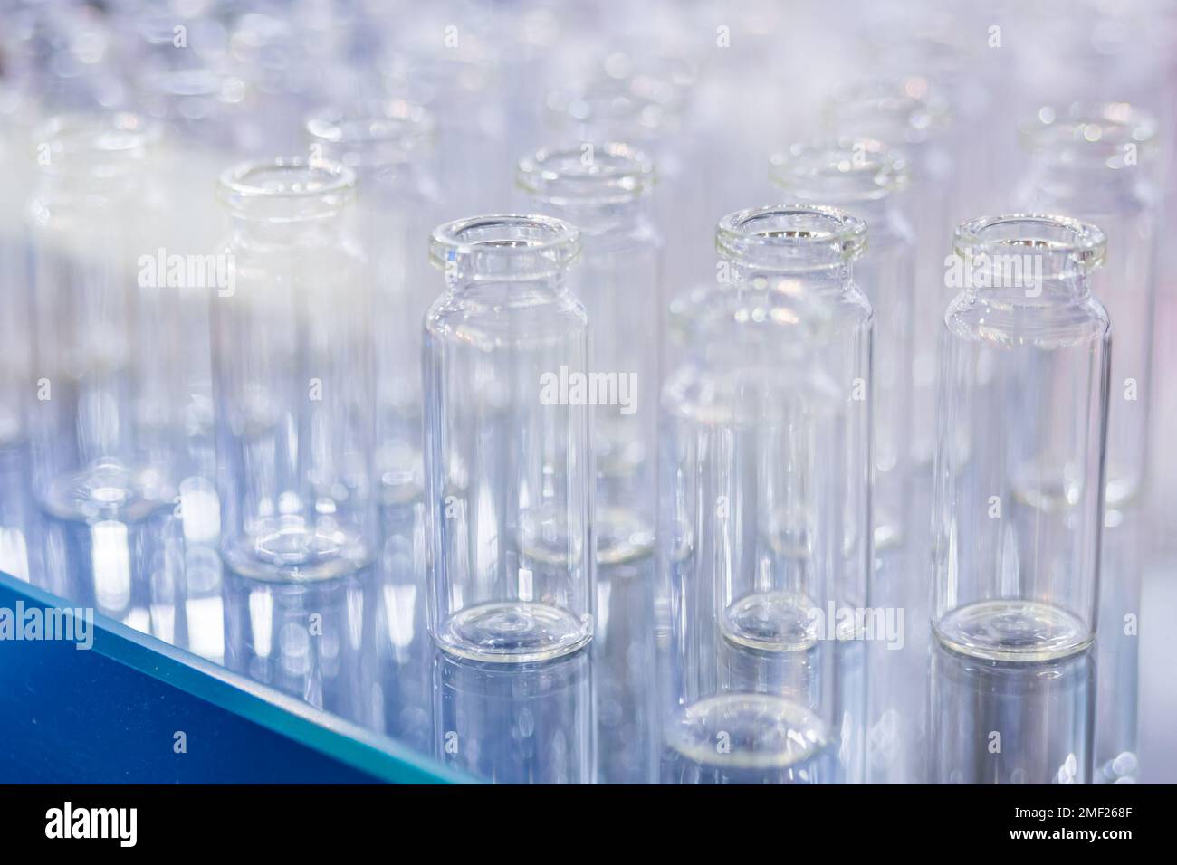 Medical empty glass bottles in showcase at pharmaceutical exhibition ...