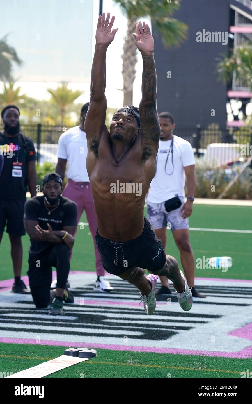 Texas A&M wide receiver Jhamon Ausbon stretches during the broad jump ...