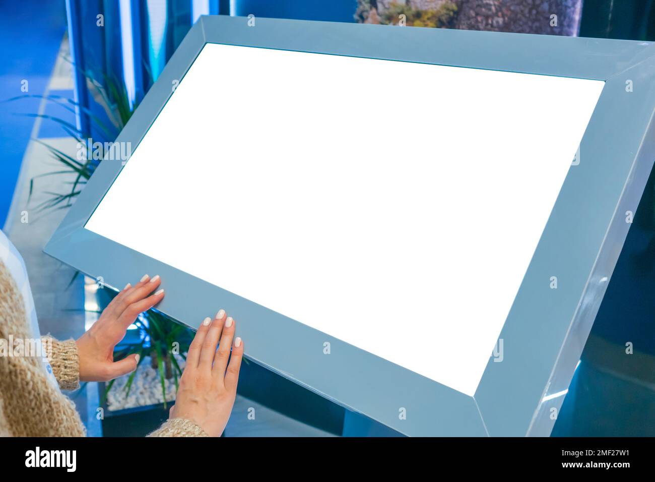 White screen concept - woman looking at blank interactive white display ...