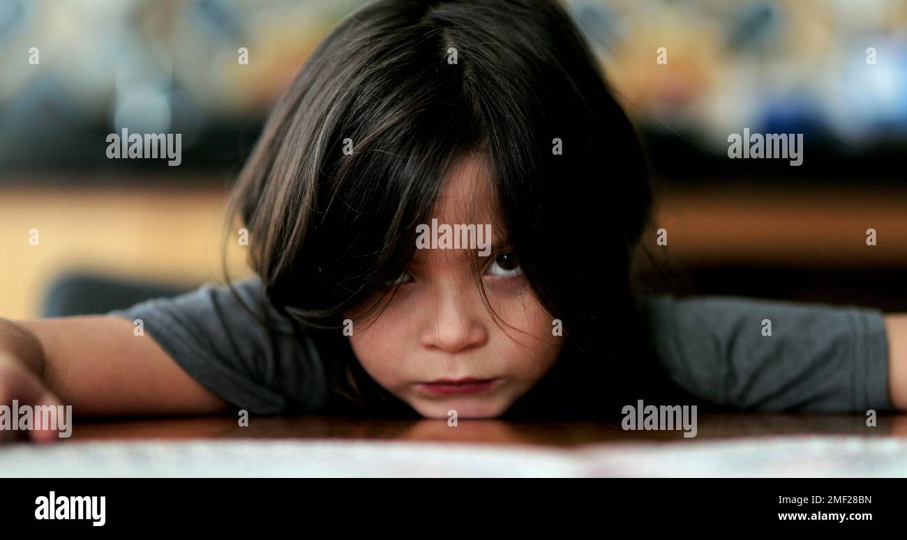 Child becoming serious and sad kid emotional change Stock Photo - Alamy