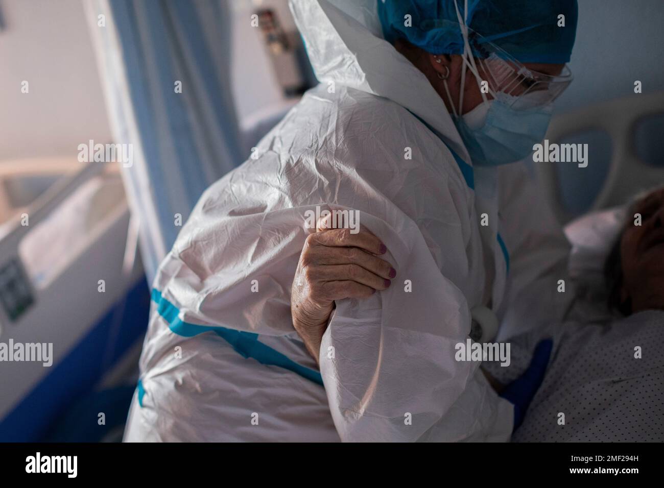 Nurse assistant Ainara Ruiz lifts a coronavirus patient in the Severo ...