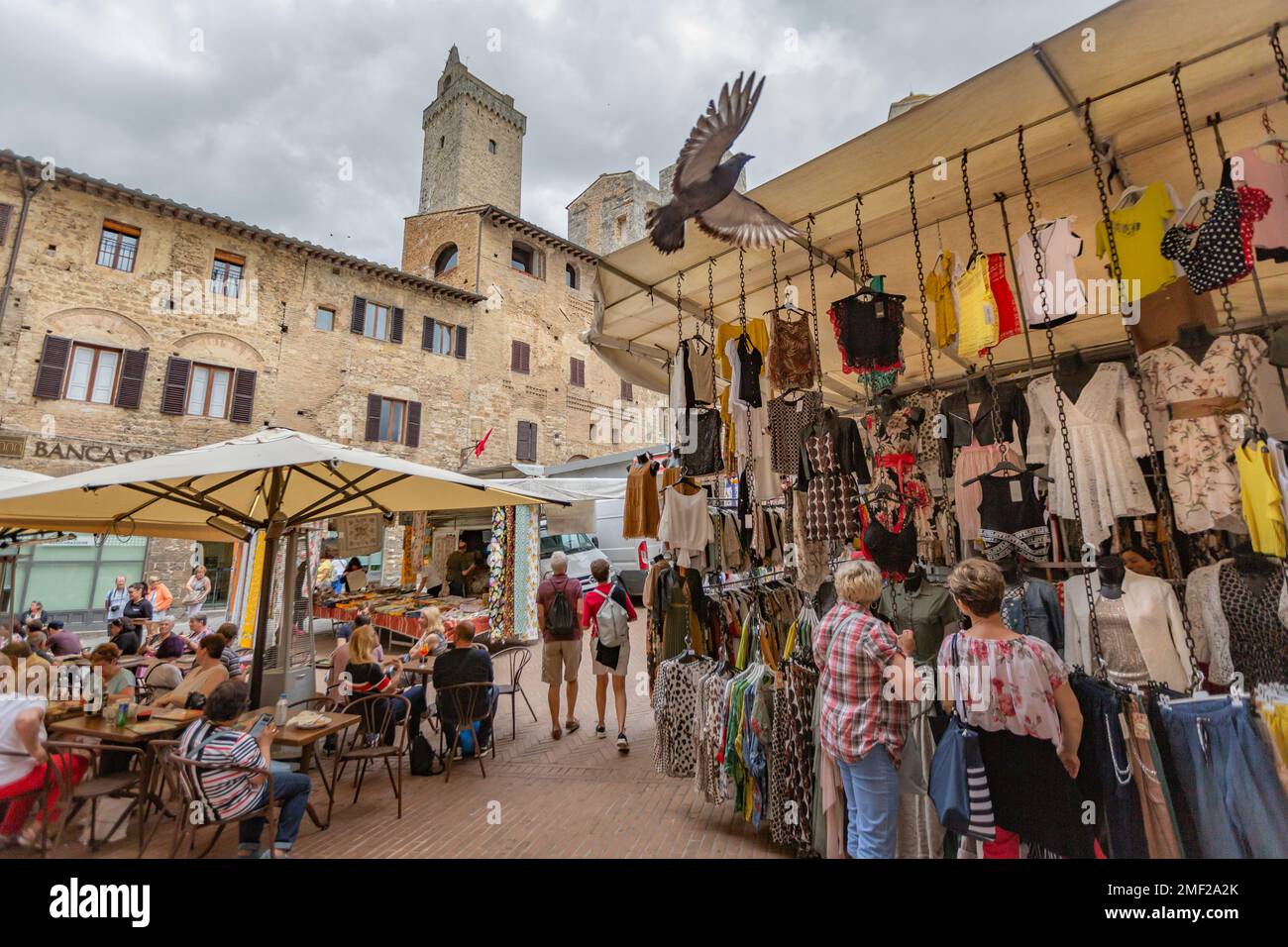 People shopping at outdoor market in San Gimignano, Tuscany, Italy ...