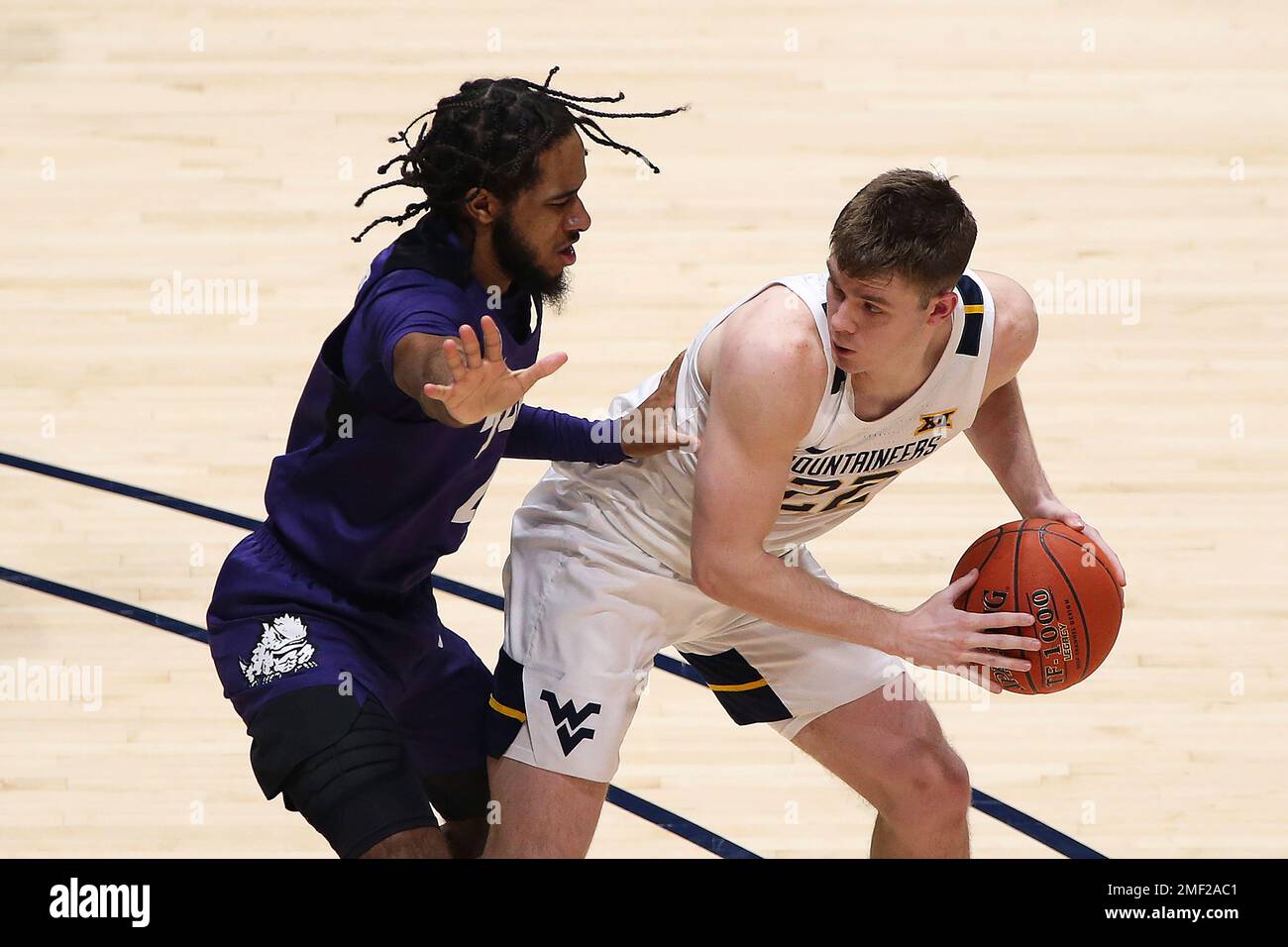 West Virginia guard Sean McNeil (22) is defended by TCU guard PJ Fuller ...
