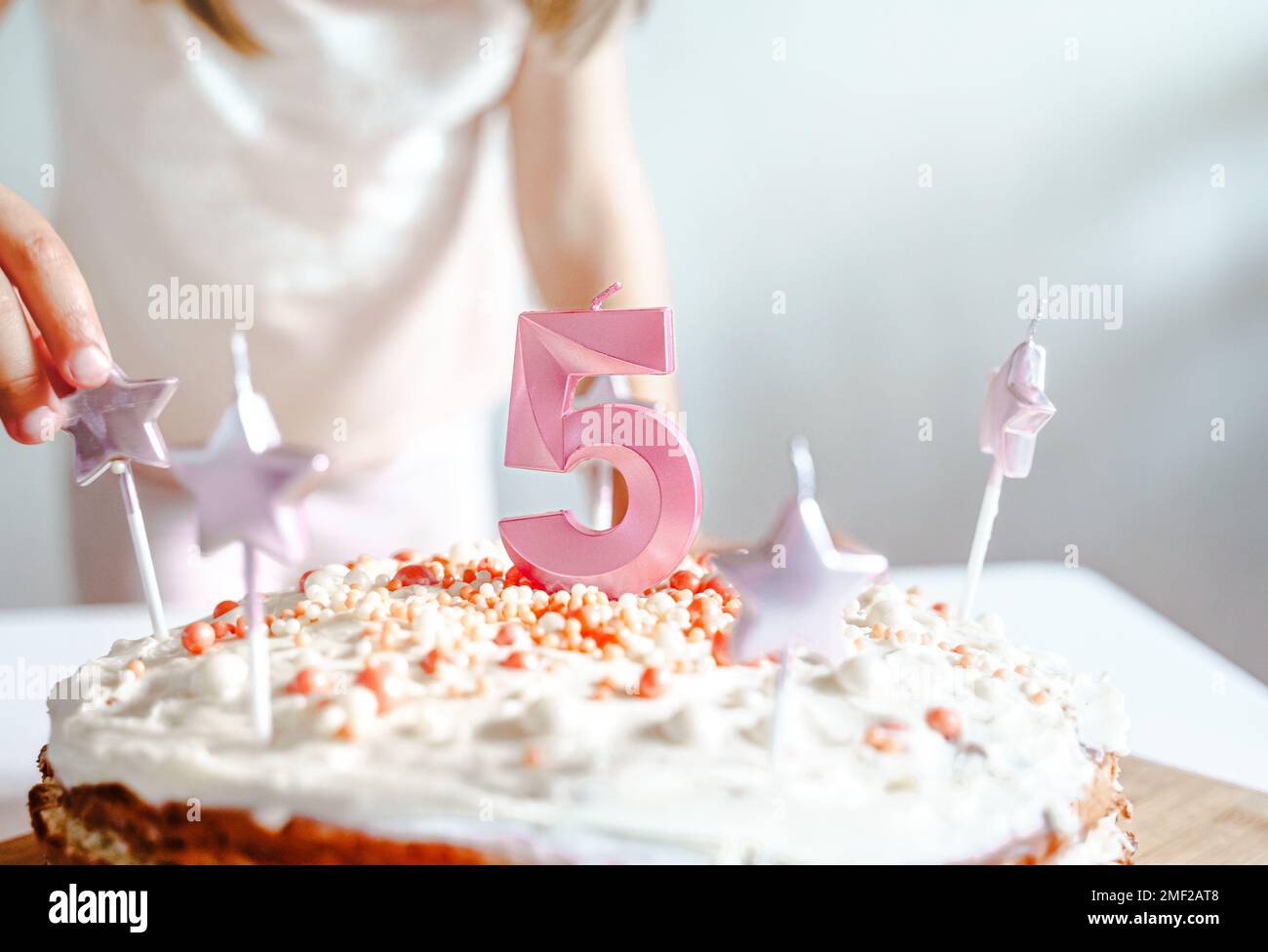 Big pink 5 number candle on homemade cake. Creative congratulations on ...