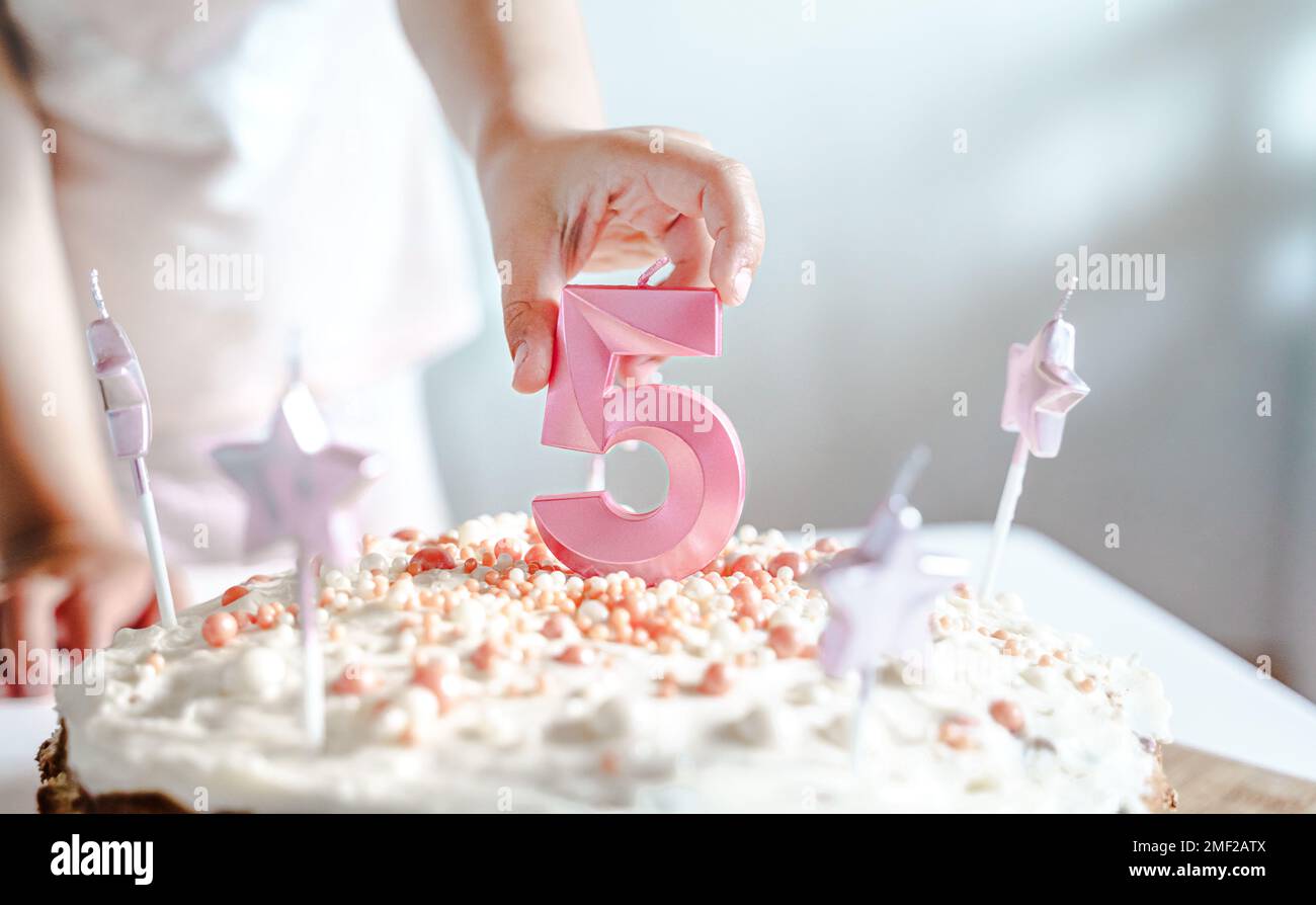 Big pink 5 number candle on homemade cake. Creative congratulations on ...