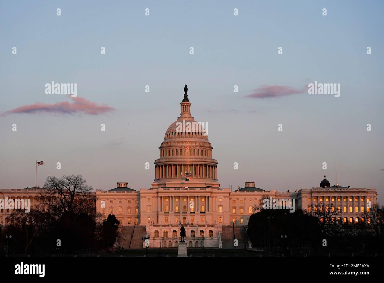 The sun sets on the U.S. Capitol building, Thursday, March 4, 2021, in ...