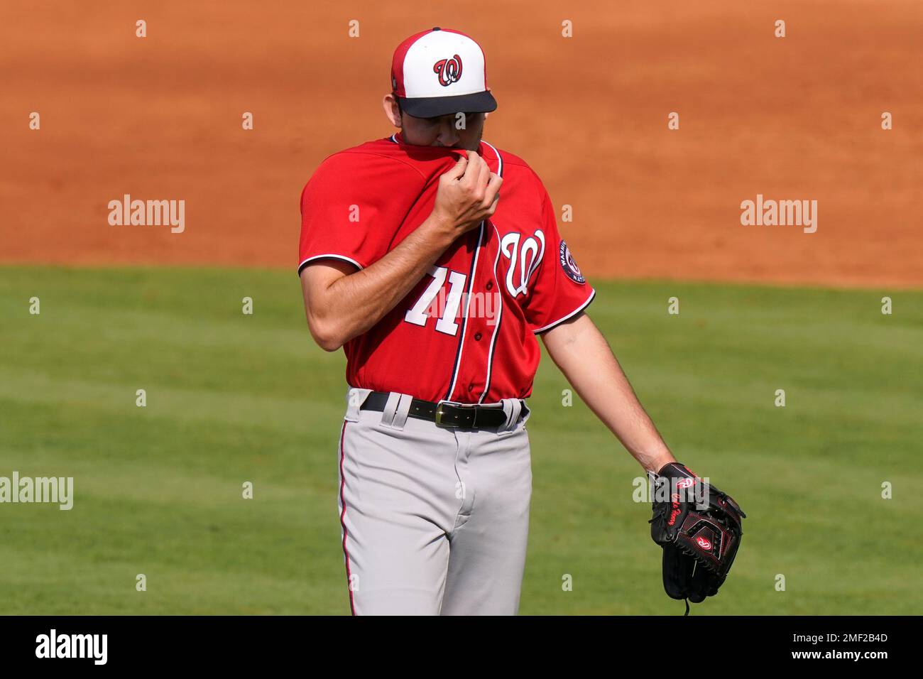 Washington Nationals relief pitcher Cole Henry reacts on the mound with ...