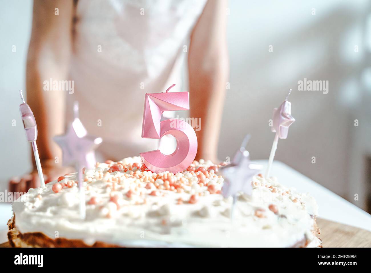 Big pink 5 number candle on homemade cake. Creative congratulations on ...