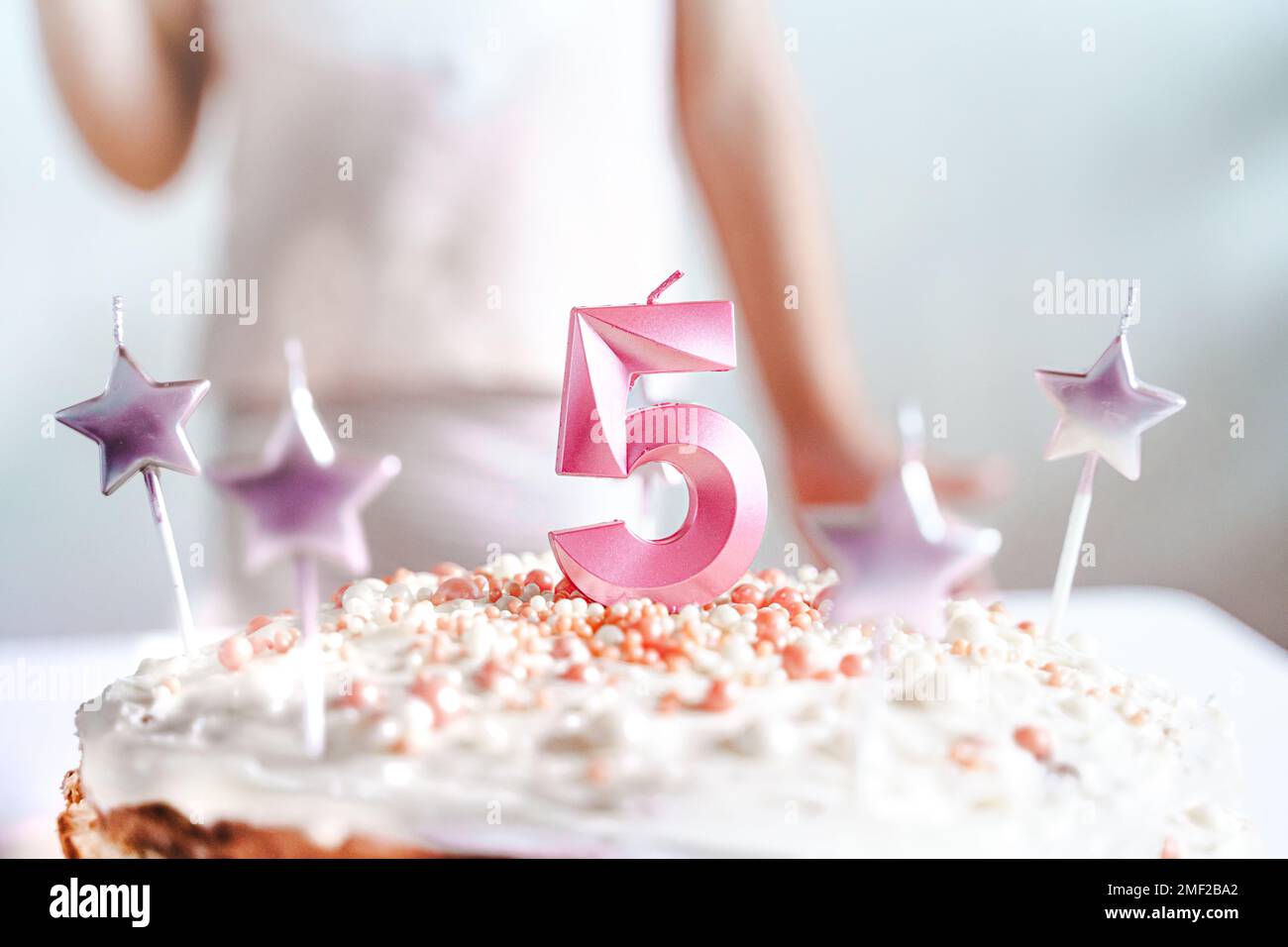 Big pink 5 number candle on homemade cake. Creative congratulations on ...