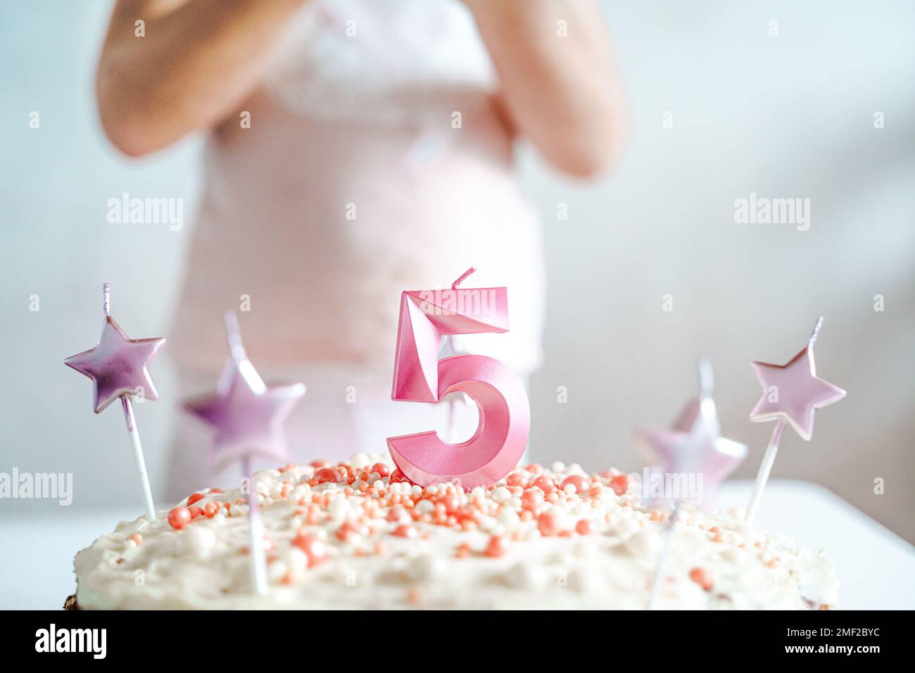 Big pink 5 number candle on homemade cake. Creative congratulations on ...