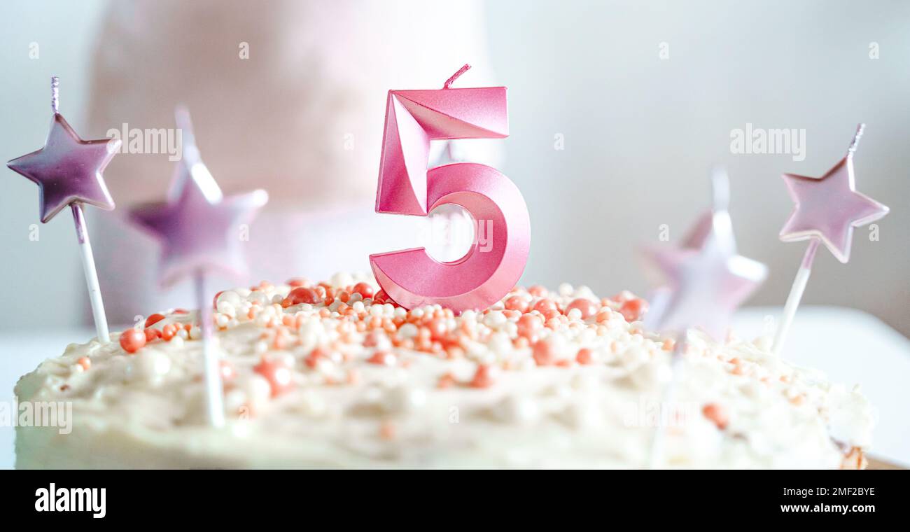 Big pink 5 number candle on homemade cake. Creative congratulations on ...