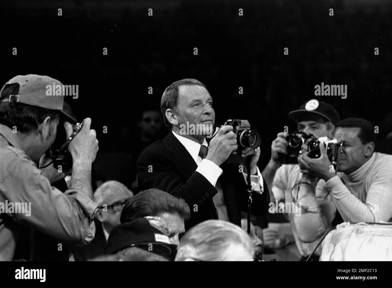 FILE - Frank Sinatra is photographed as he takes pictures at the Joe ...