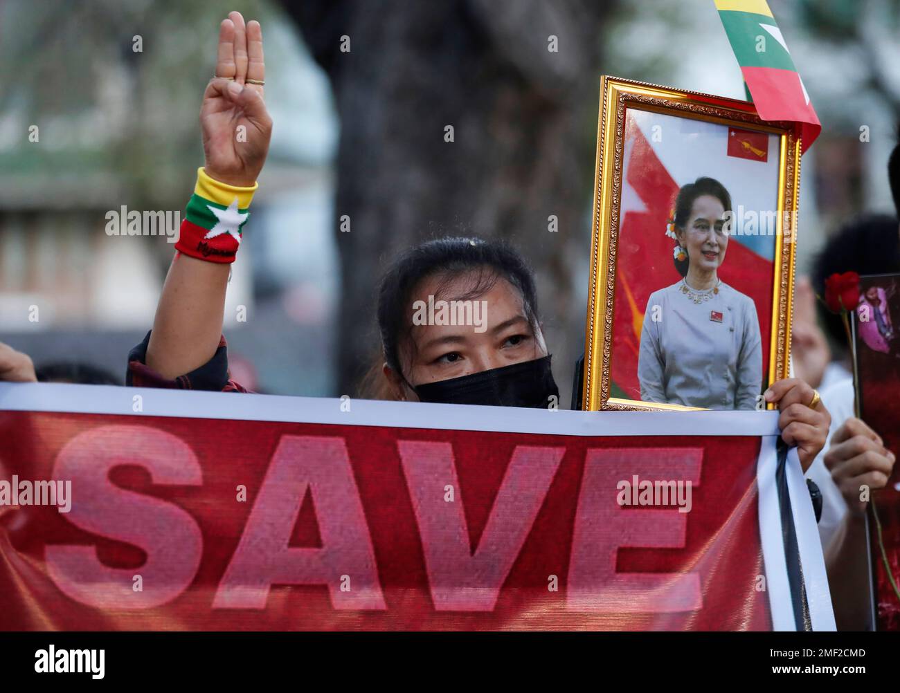 Myanmar nationals living in Thailand gesture with a three-finger sign ...